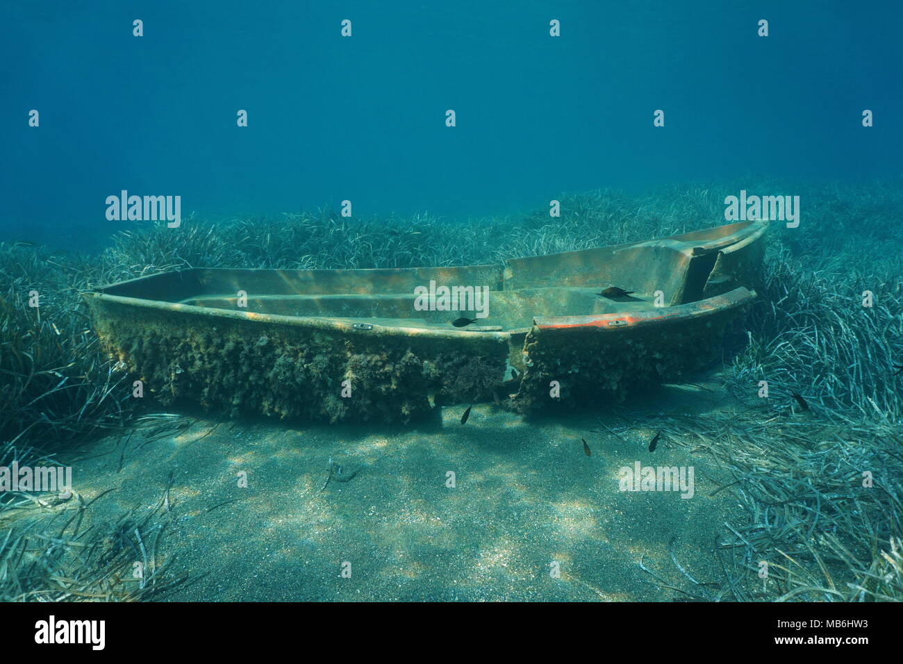 A small wrecked boat underwater on the seabed in the Mediterranean sea ...
