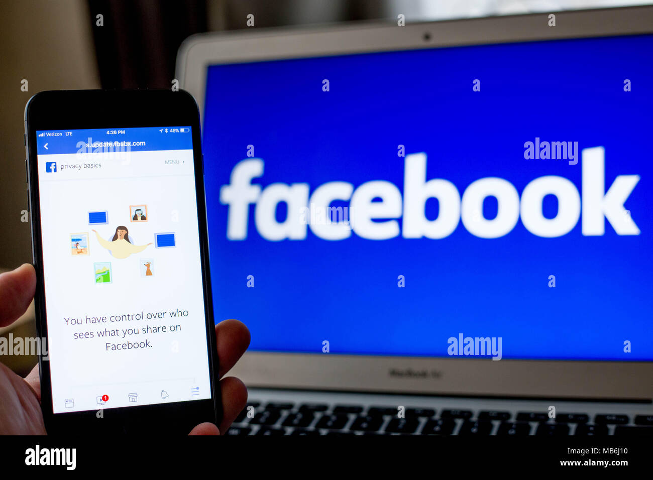 In a photo illustration, a screen from the Facebook app is seen on an ...