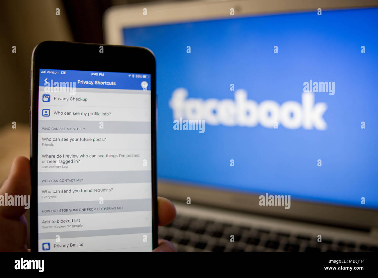 In a photo illustration, a screen from the Facebook app is seen on an ...