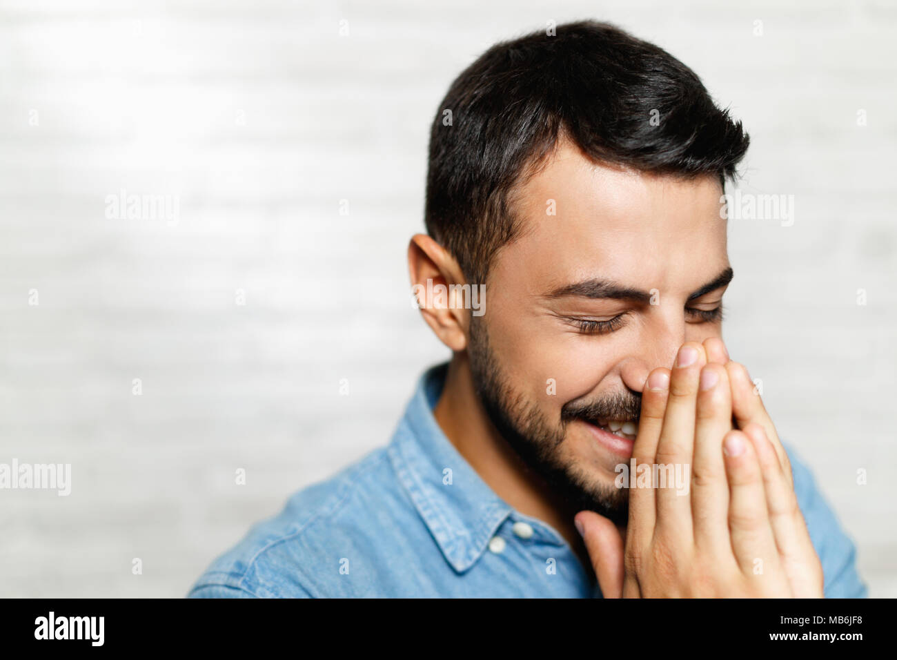 Facial Expressions Of Young Beard Man On Brick Wall Stock Photo - Alamy