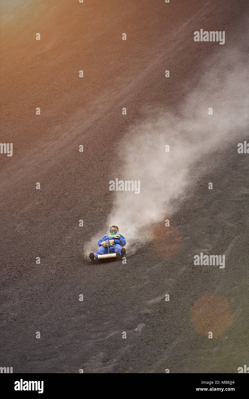 Activity tour in Nicaragua. Young woman ride volcano boarding Stock ...