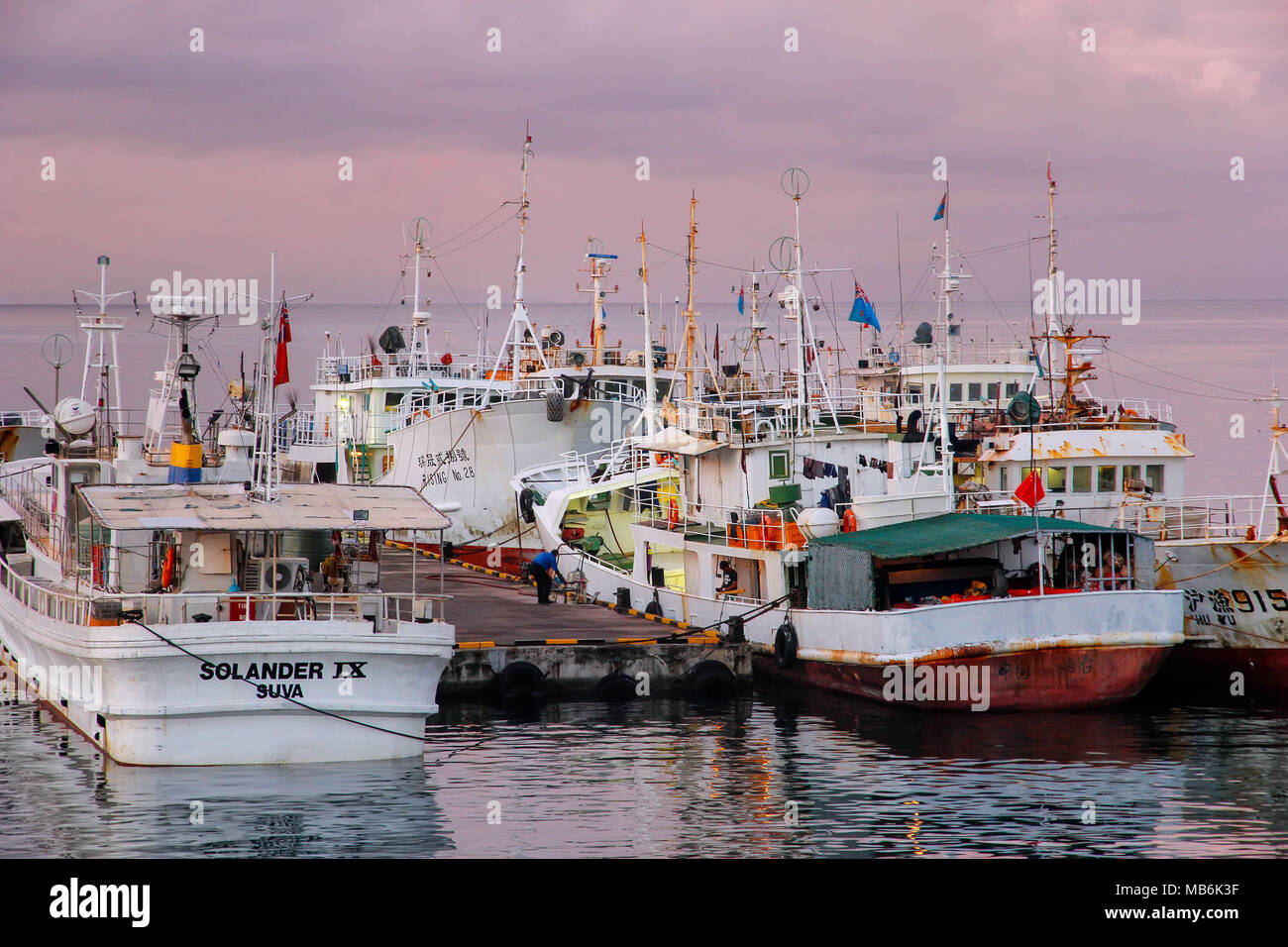 Boats at Suva port at sunrise, Viti Levu Island, Fiji. Suva is ...
