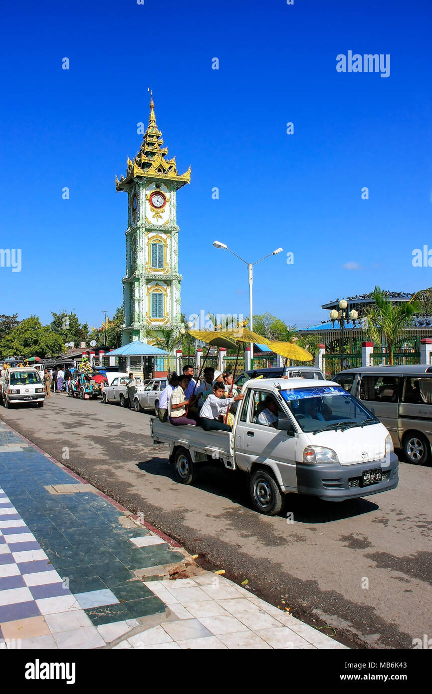 Local men riding in a truck near Clock tower at Mahamuni Pagoda complex ...