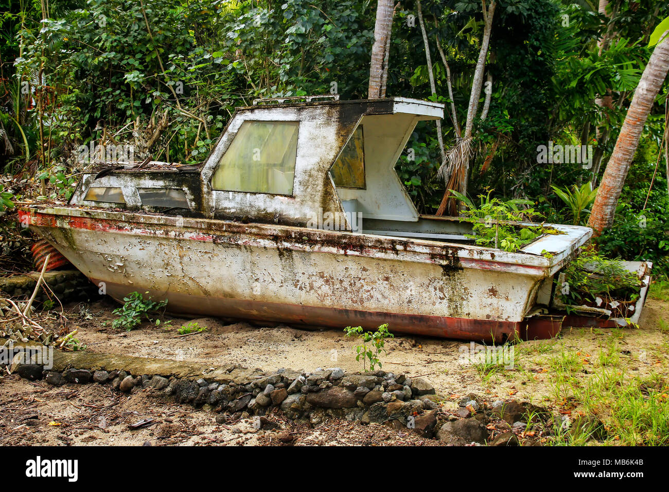 Abandoned boat on the shore of Nananu-i-Ra island, Fiji. Tourism is the ...