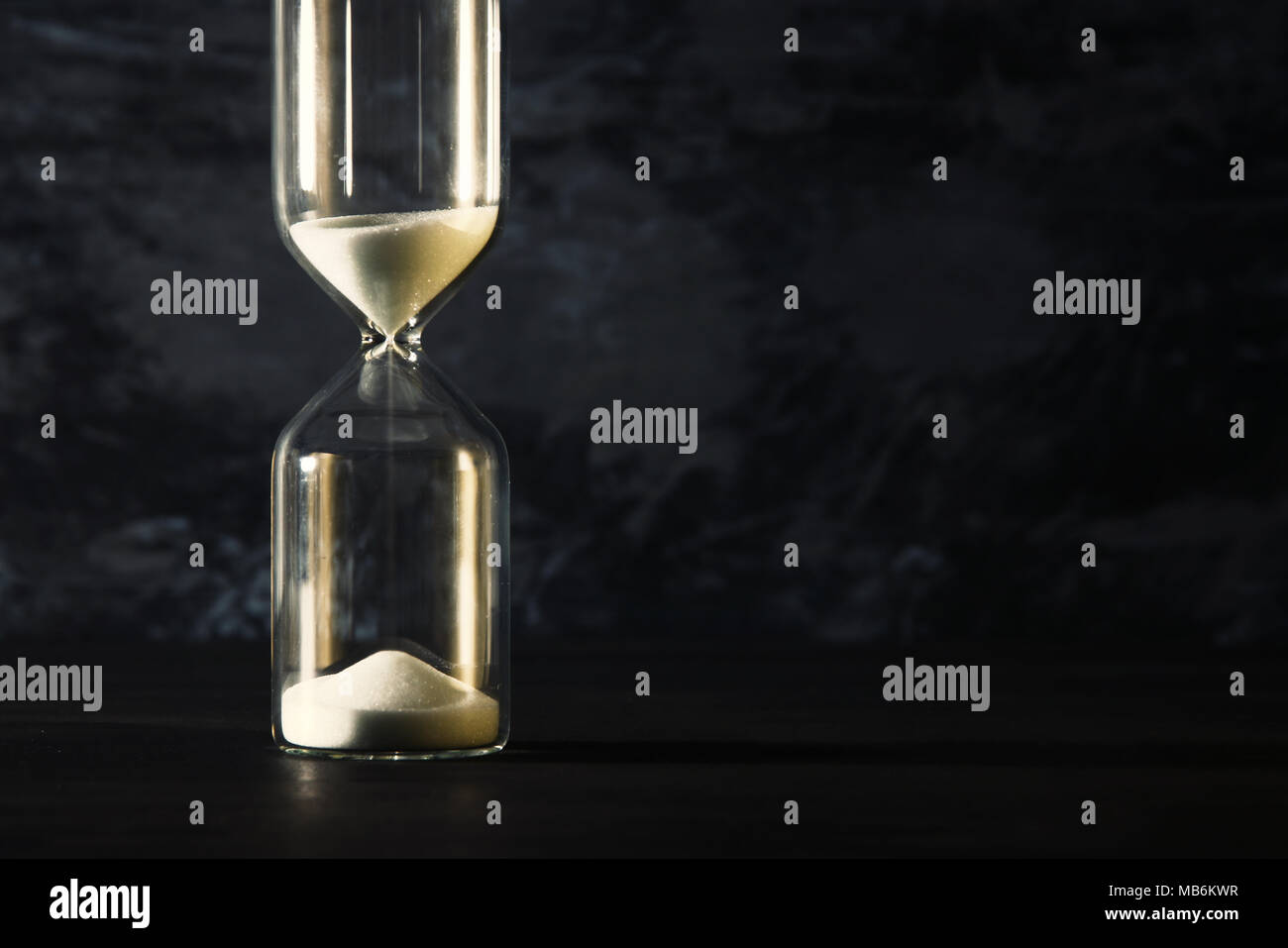 Image of hourglass as time passing concept over black background for ...