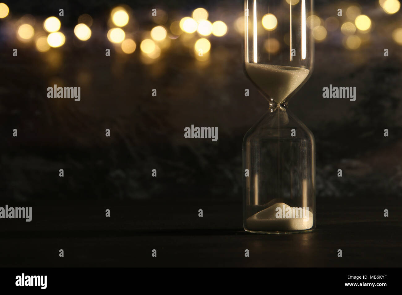 Image of hourglass as time passing concept over black background for ...