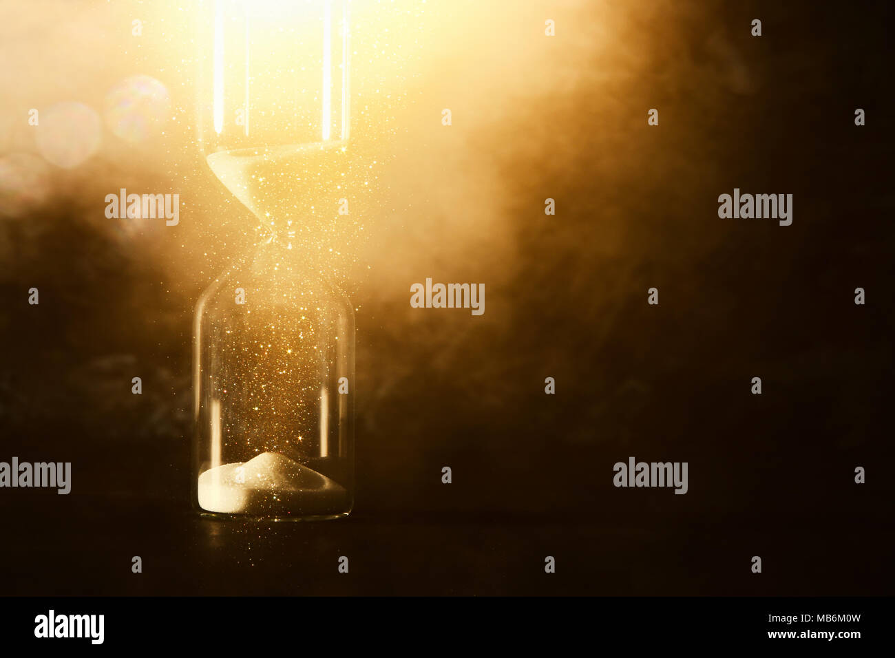 Image of hourglass as time passing concept over black background for ...