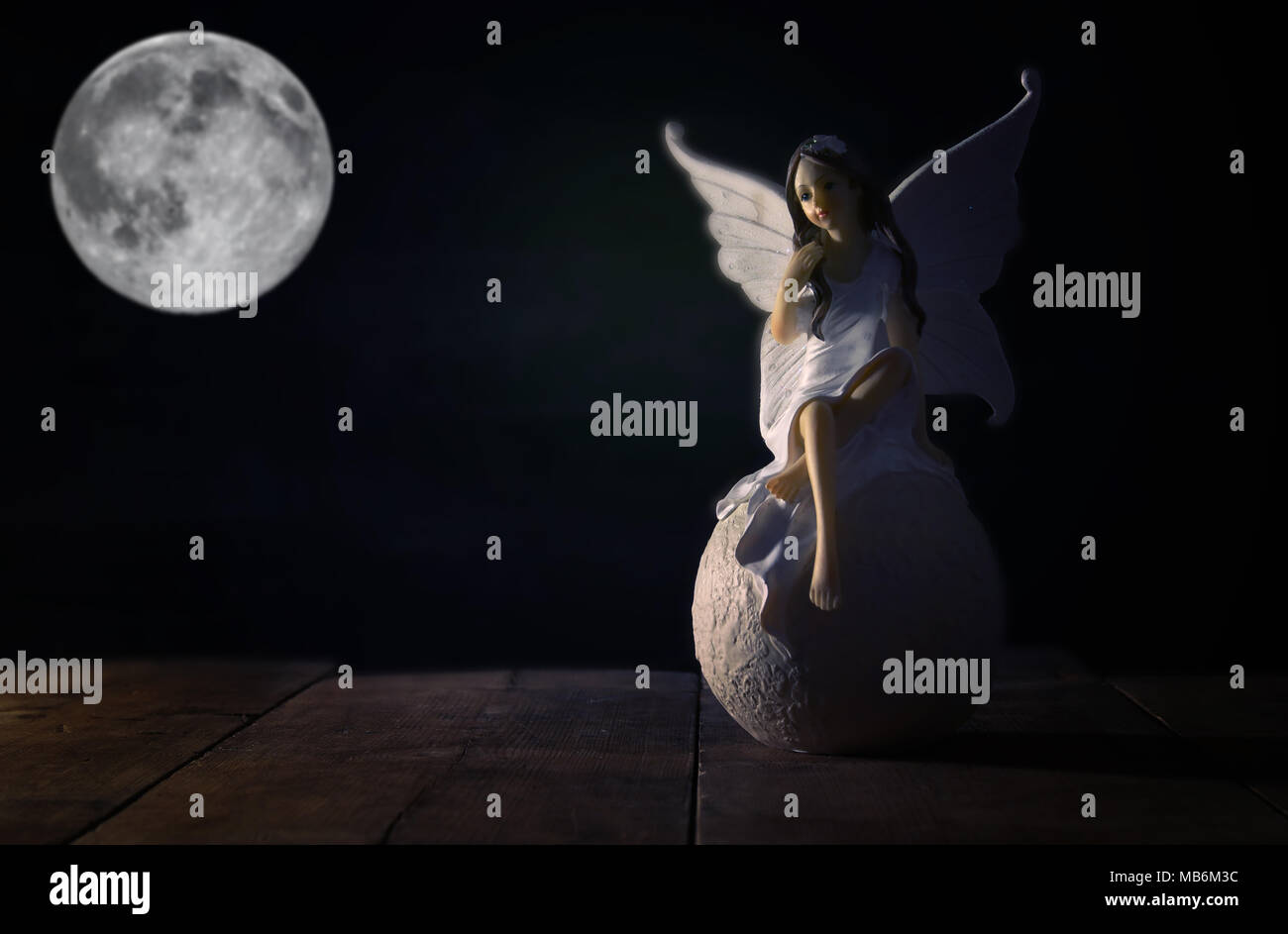 image of magical little fairy sitting over the stone Stock Photo - Alamy