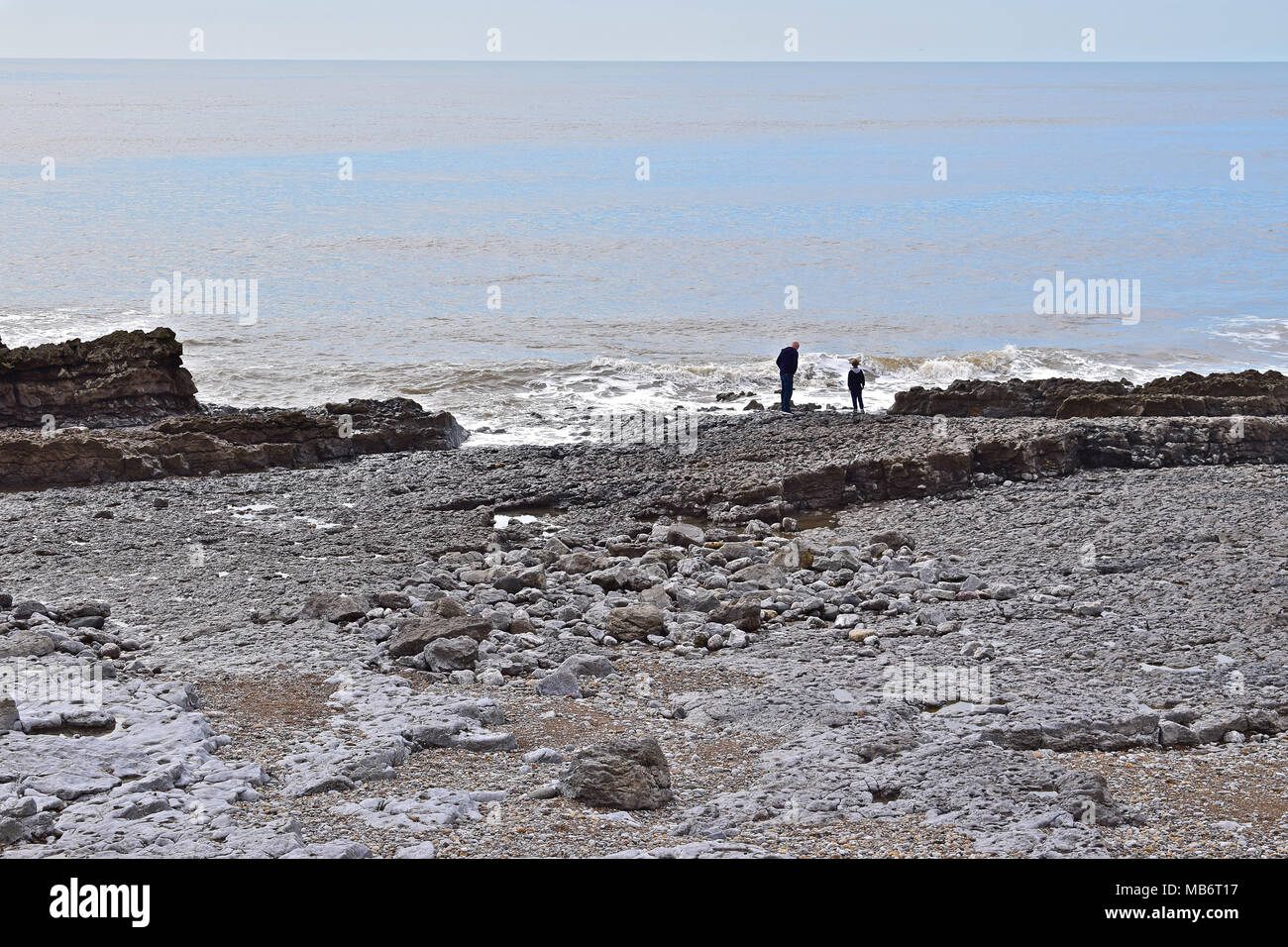 Boy standing sea watching waves hi-res stock photography and images - Alamy