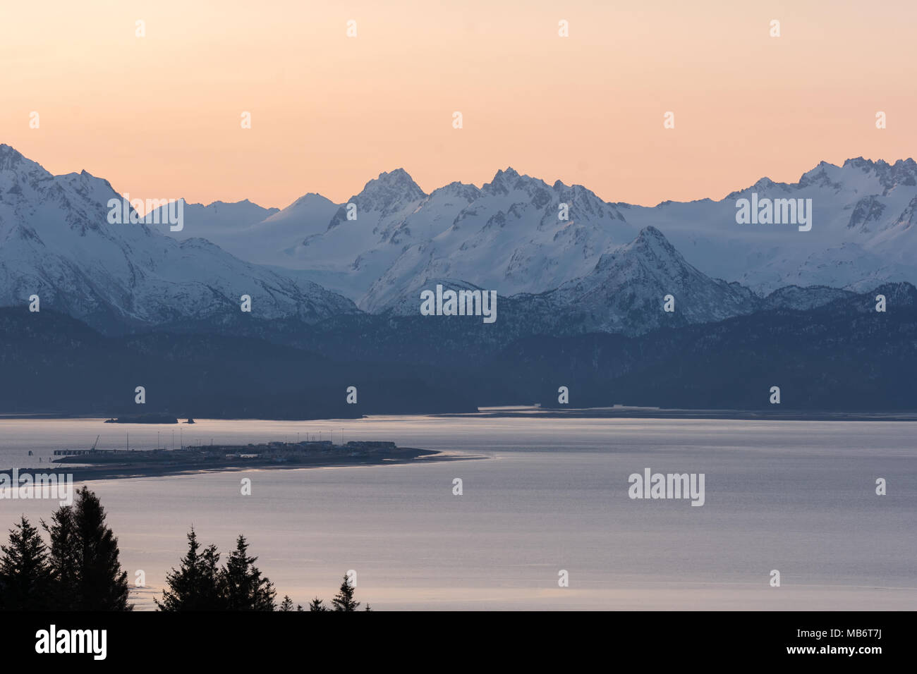 The Homer Spit is quiet in the pre dawn light with the Kenai Mountains ...