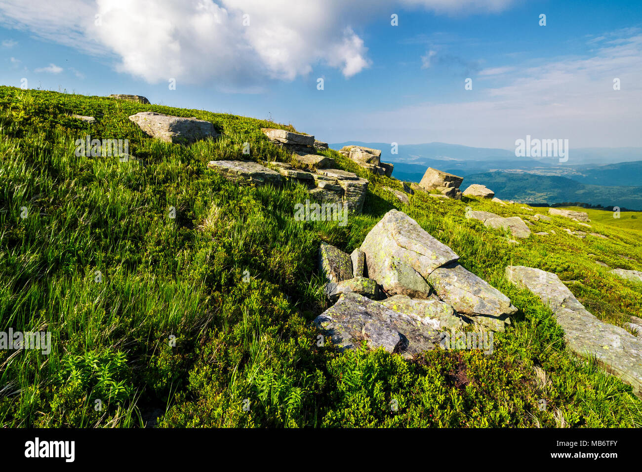 grassy hill with lots of boulders. lovely mountainous landscape. fine ...