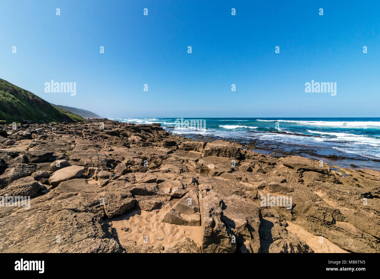 Rocks sand ocean and blue coastal skyline at Mission Rocks beach near ...