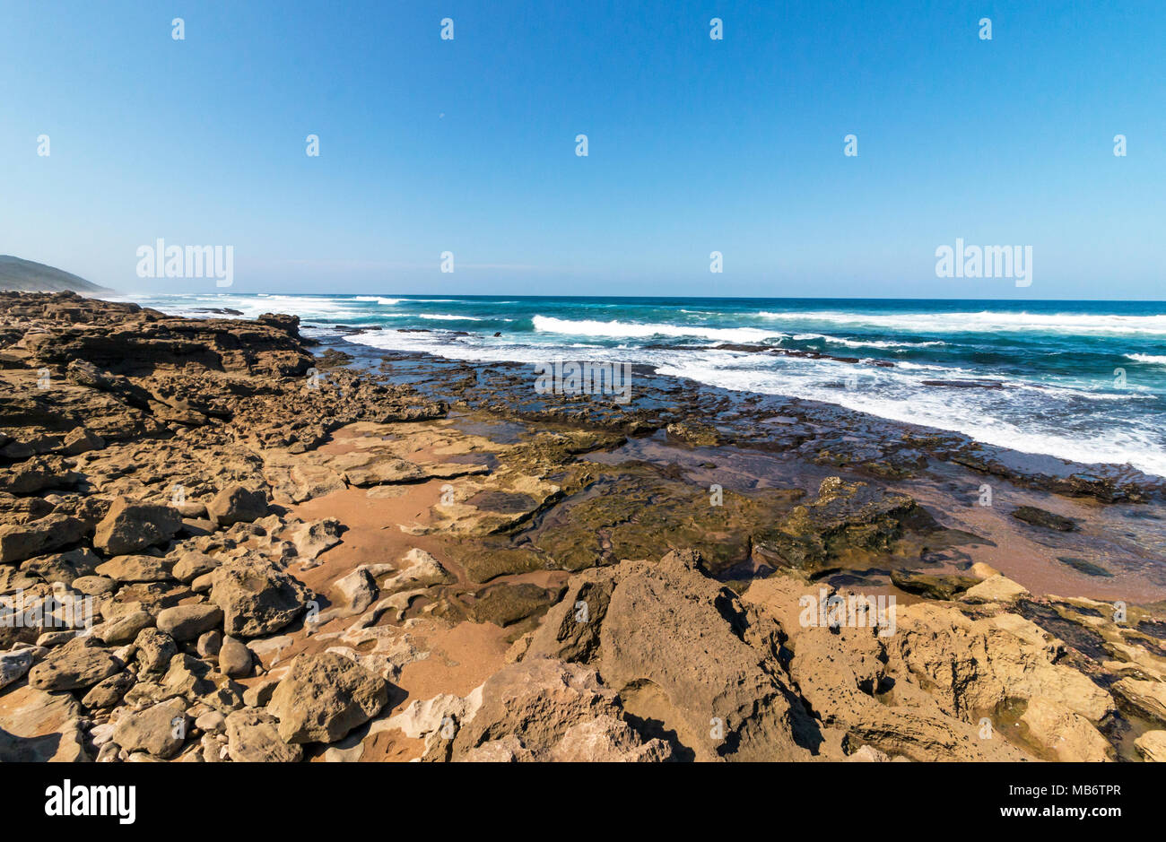Rocks sand ocean and blue coastal skyline at Mission Rocks beach near ...