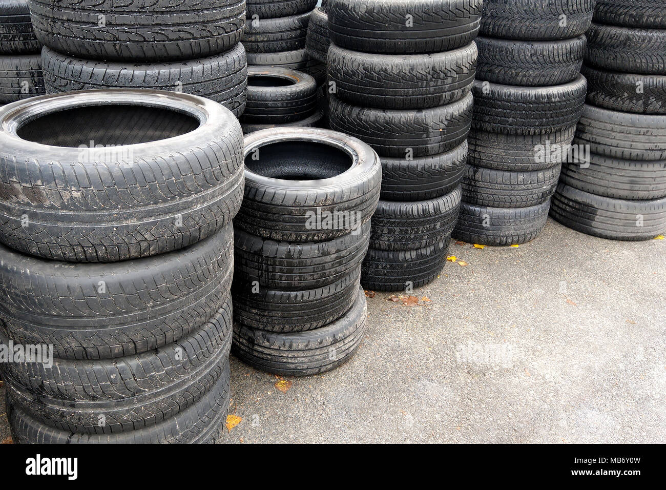 Used car tires stacked in piles at junkyard. Old wheels recycling and utilization Stock Photo ...