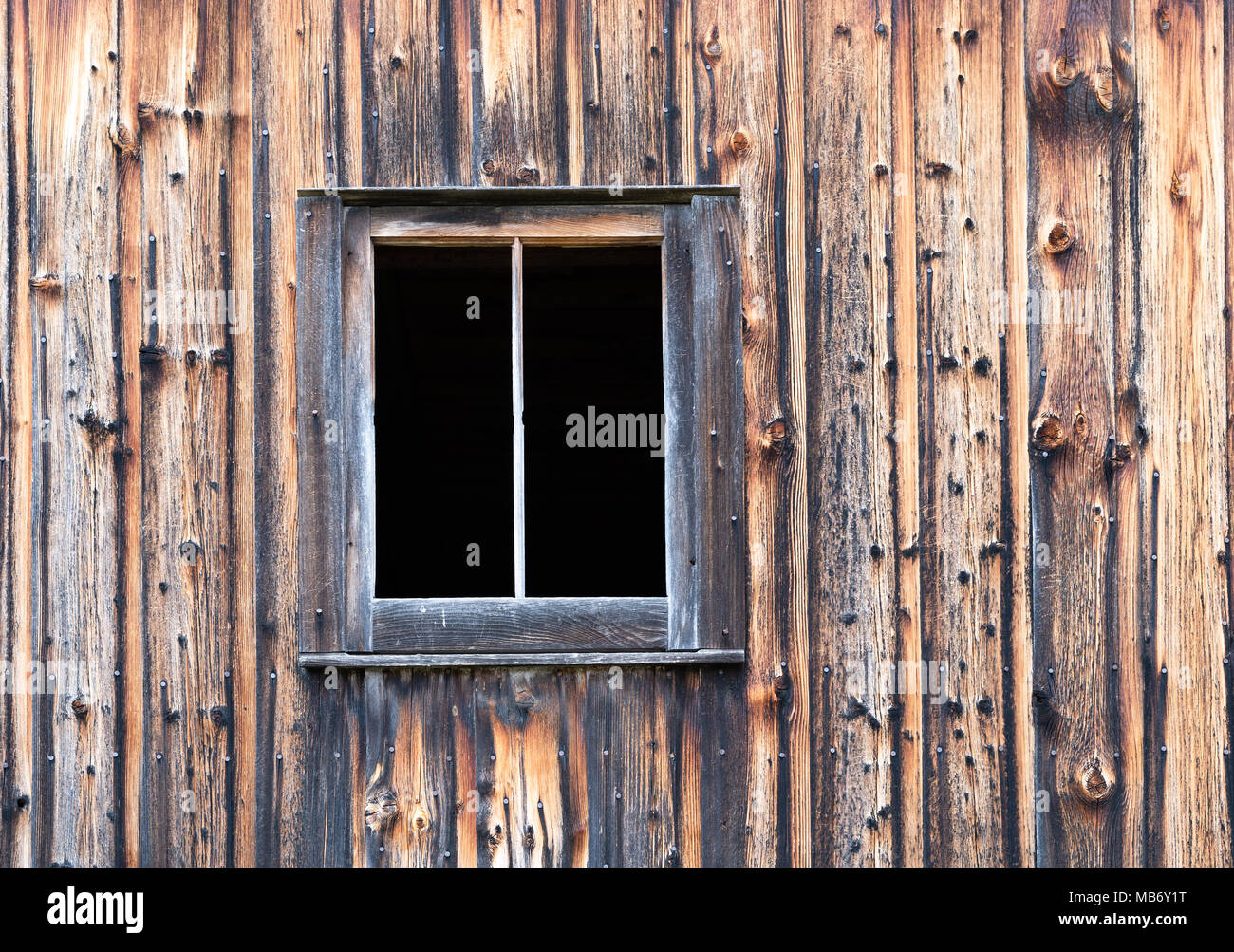 Close up of Distressed Barn Wall with Window has Light and Dark Boards ...