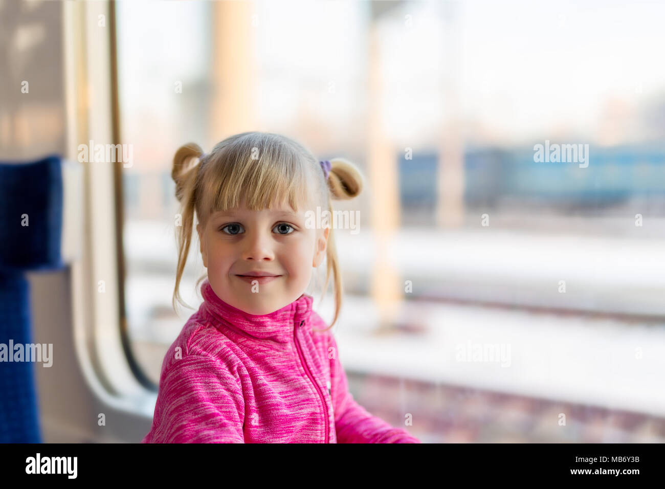 Cute kid girl travelling by raailroad. Child smiling and sitting in ...
