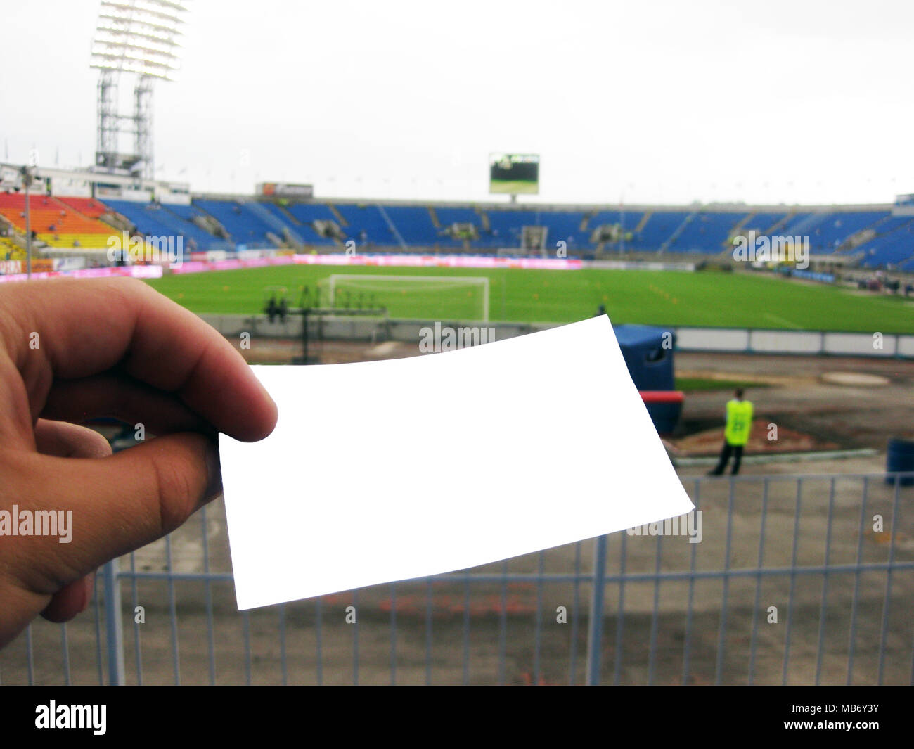 Man in the stadium stands holding a ticket in his hand Stock Photo - Alamy