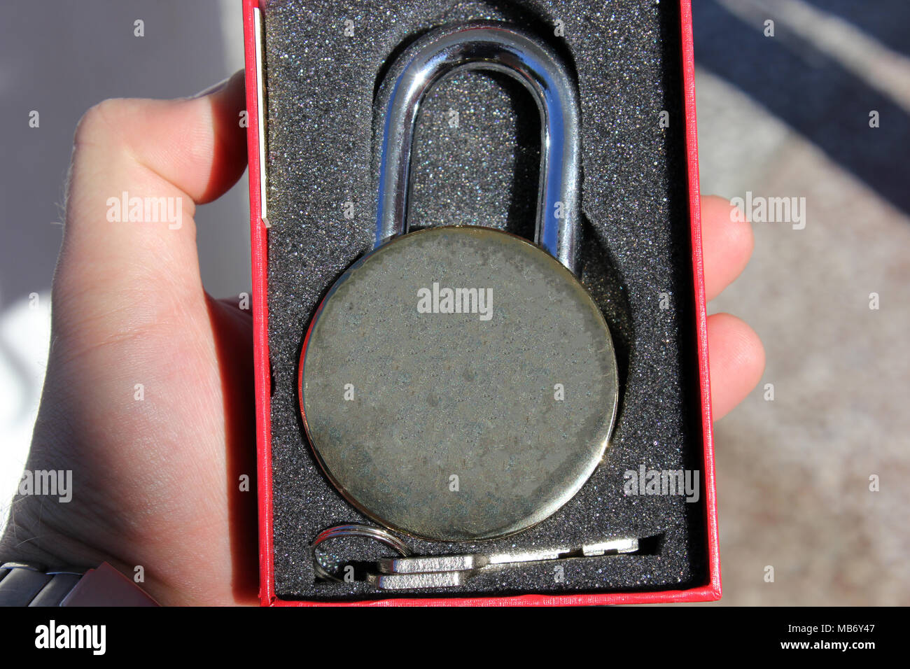 Man holds an old lock in his hand Stock Photo - Alamy