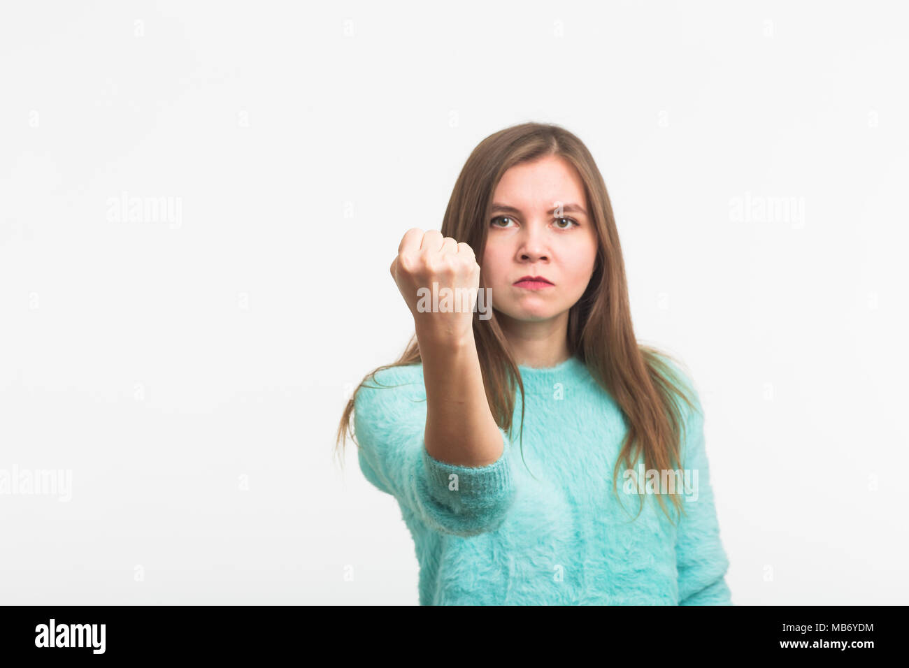 Angry aggressive woman with ferocious expression on white background ...