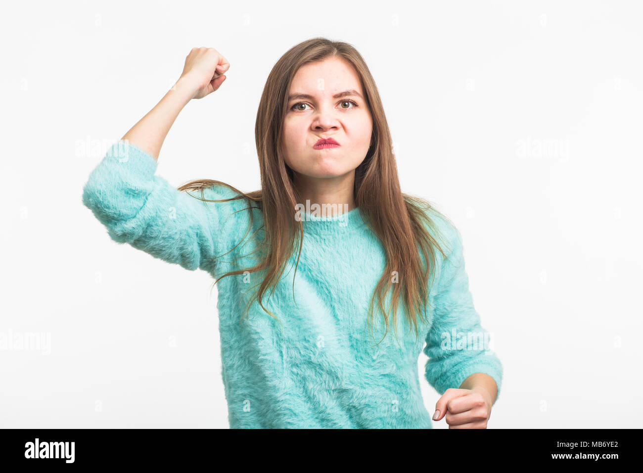 Angry aggressive woman with ferocious expression on white background ...
