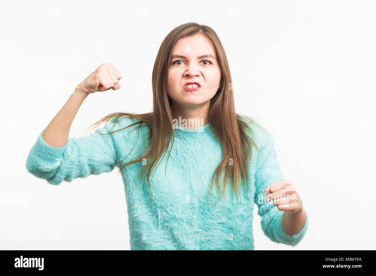 Angry aggressive woman with ferocious expression on white background ...