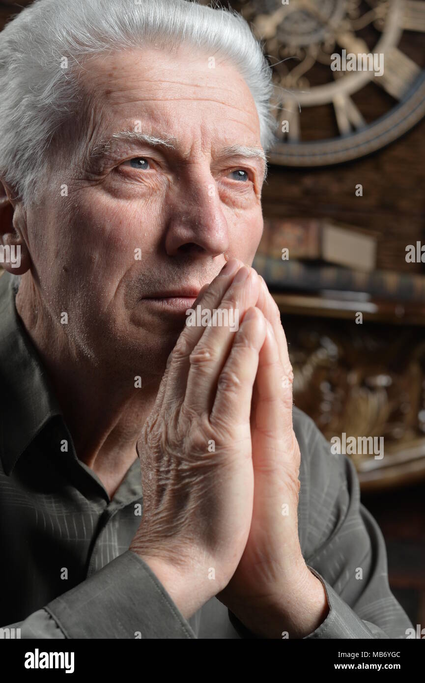 Portrait of Sad senior man praying Stock Photo - Alamy