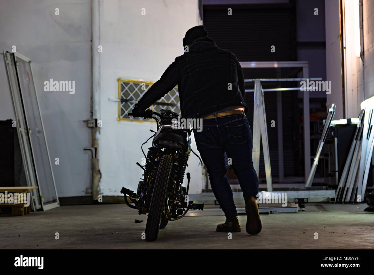 Picture of my friend pushing his motorcycle Stock Photo - Alamy