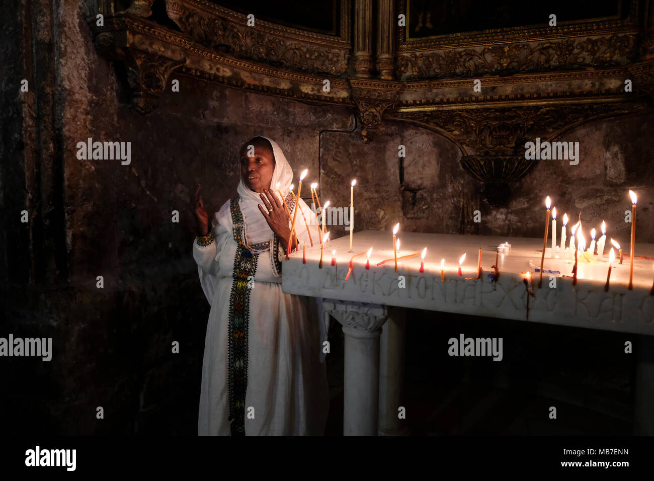 An Ethiopian Orthodox Christian pilgrim praying at the Greek Chapel of ...