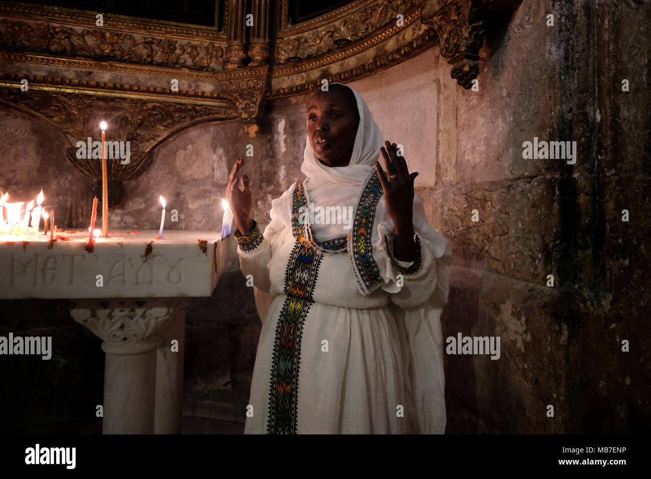 An Ethiopian Orthodox Christian pilgrim praying at the Greek Chapel of ...