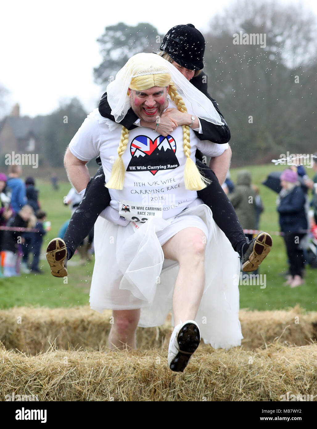 Malcolm Pernet carries Kate Barfield during the annual UK Wife Carrying ...