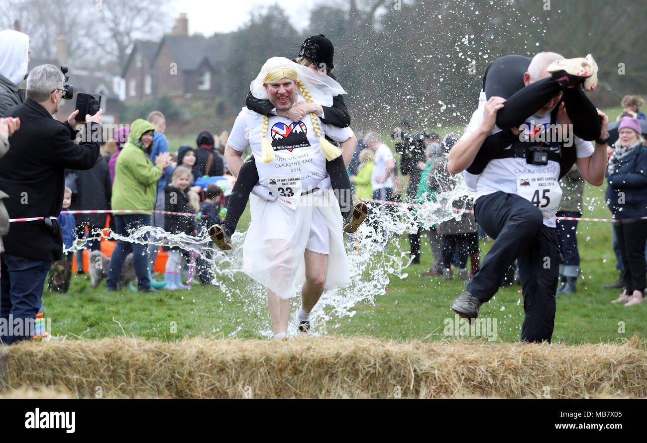 Malcolm Pernet carries Kate Barfield during the annual UK Wife Carrying ...
