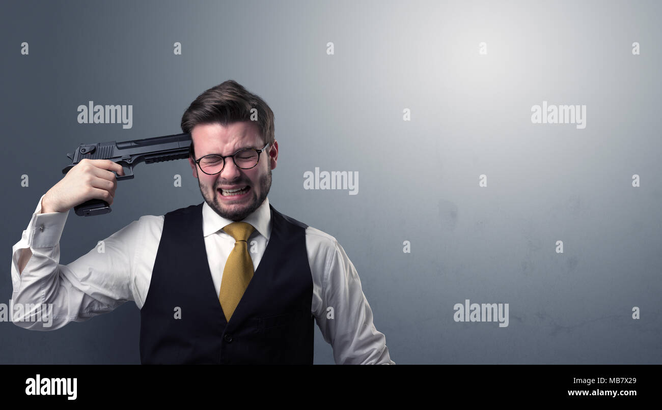 Young lost businessman man shooting his head with gun Stock Photo - Alamy