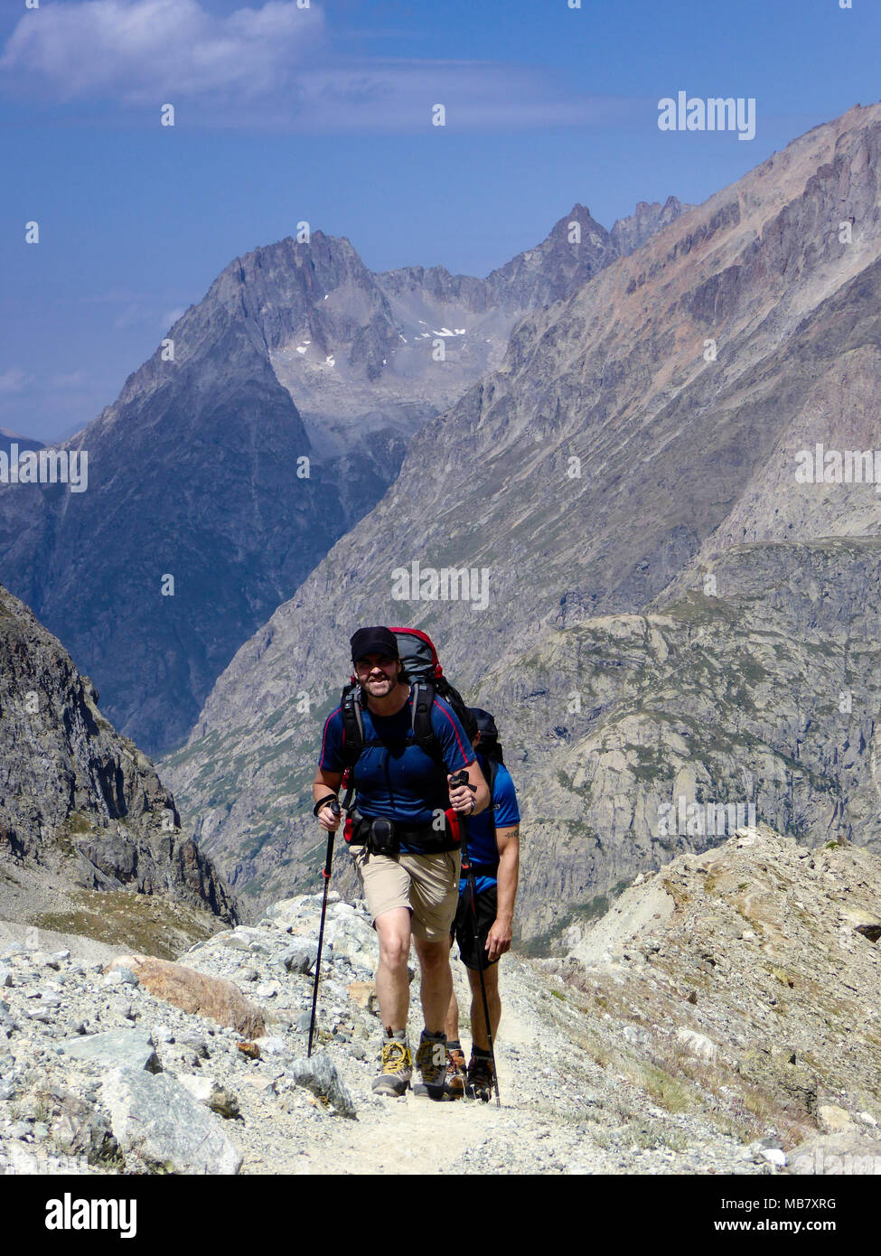 tall athletic male climber on the approach hike to a remote base camp ...