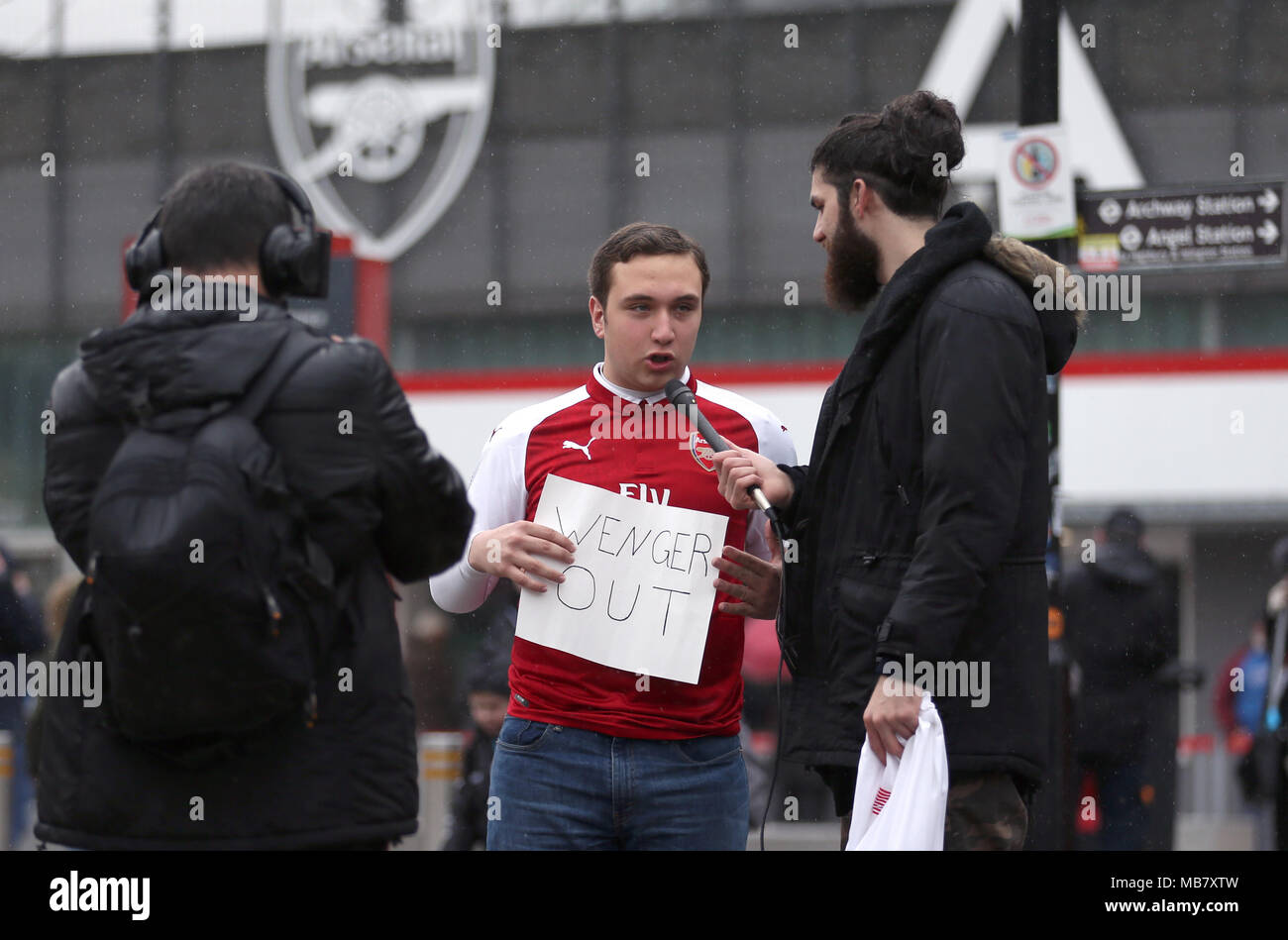 An Arsenal fan with a "Wenger Out" sign is interviewed before the ...