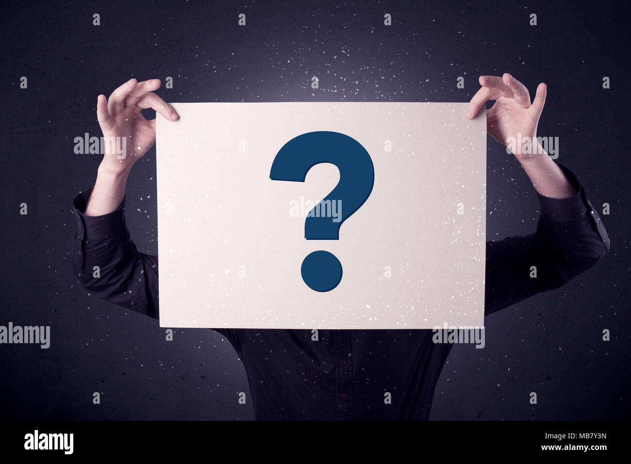 Young businessman hiding behind a question mark drawn on paper Stock ...
