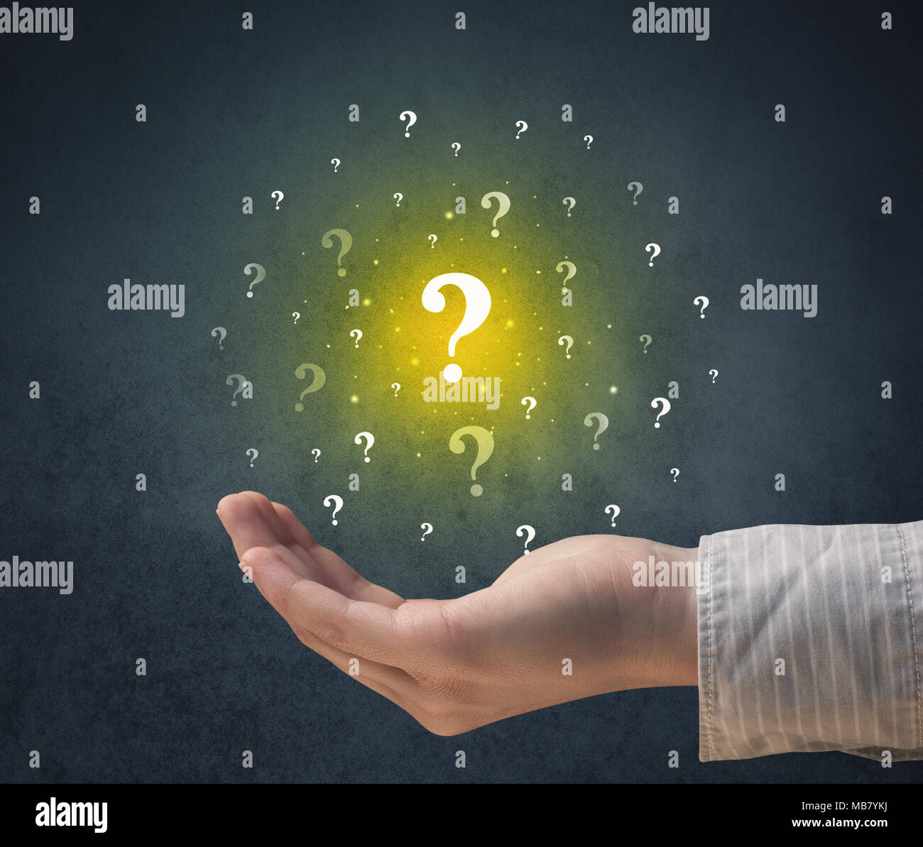 Yellow question marks hovering over young hand Stock Photo - Alamy