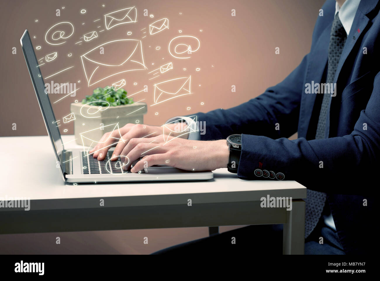 An office worker sending emails and communication with clients with the ...