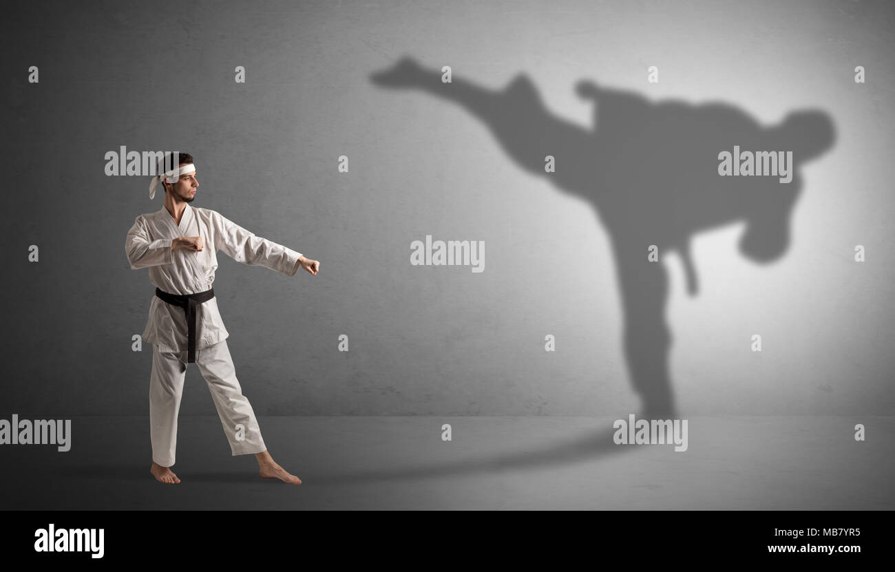 Young karate man confronting with his own shadow Stock Photo - Alamy