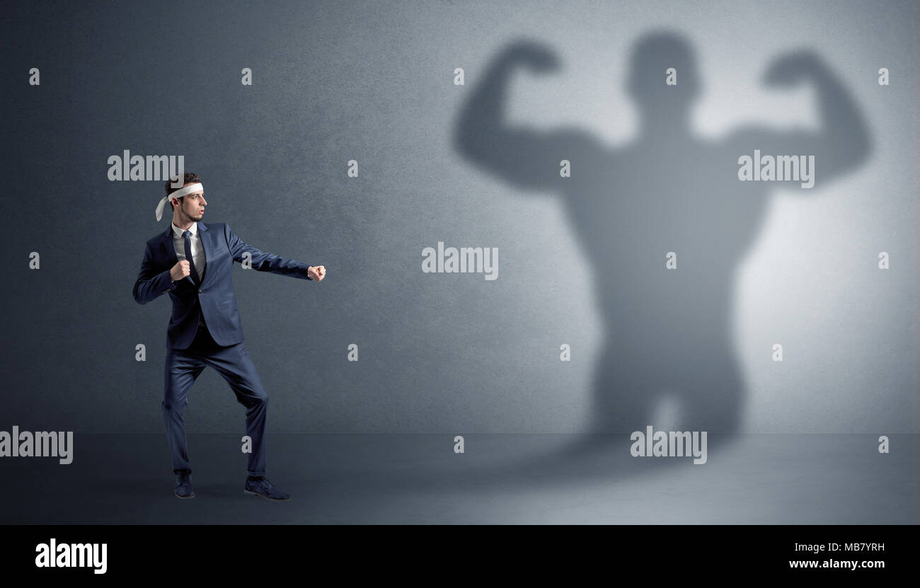 Young karate man fighting with a big black scary shadow Stock Photo - Alamy