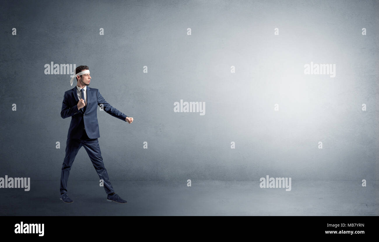 Small karate man fighting in an empty grey copy space Stock Photo - Alamy
