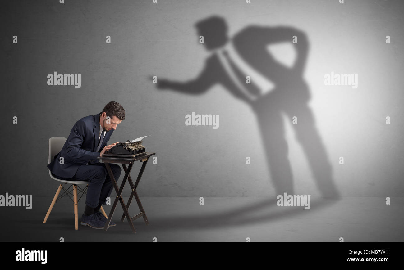 Little man working and a big shadow arguing with him Stock Photo - Alamy