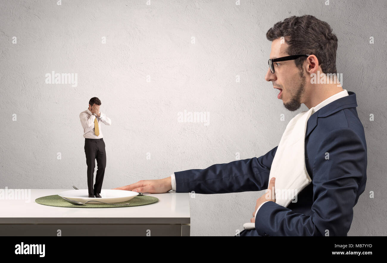 Tiny scared weak businessman almost devoured by great power Stock Photo ...