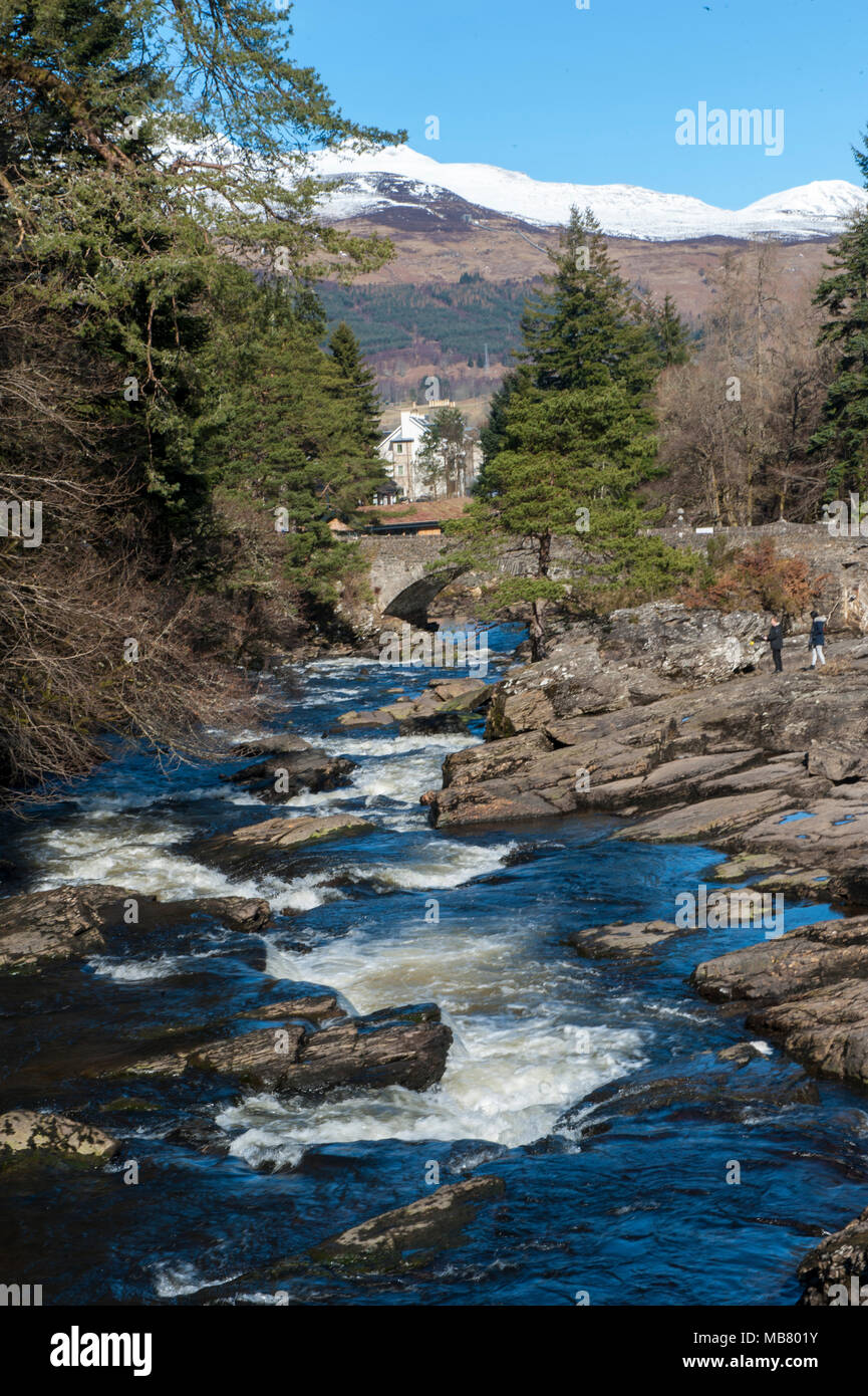 The beautiful Falls of Dochart run through the small town of Killin, in ...