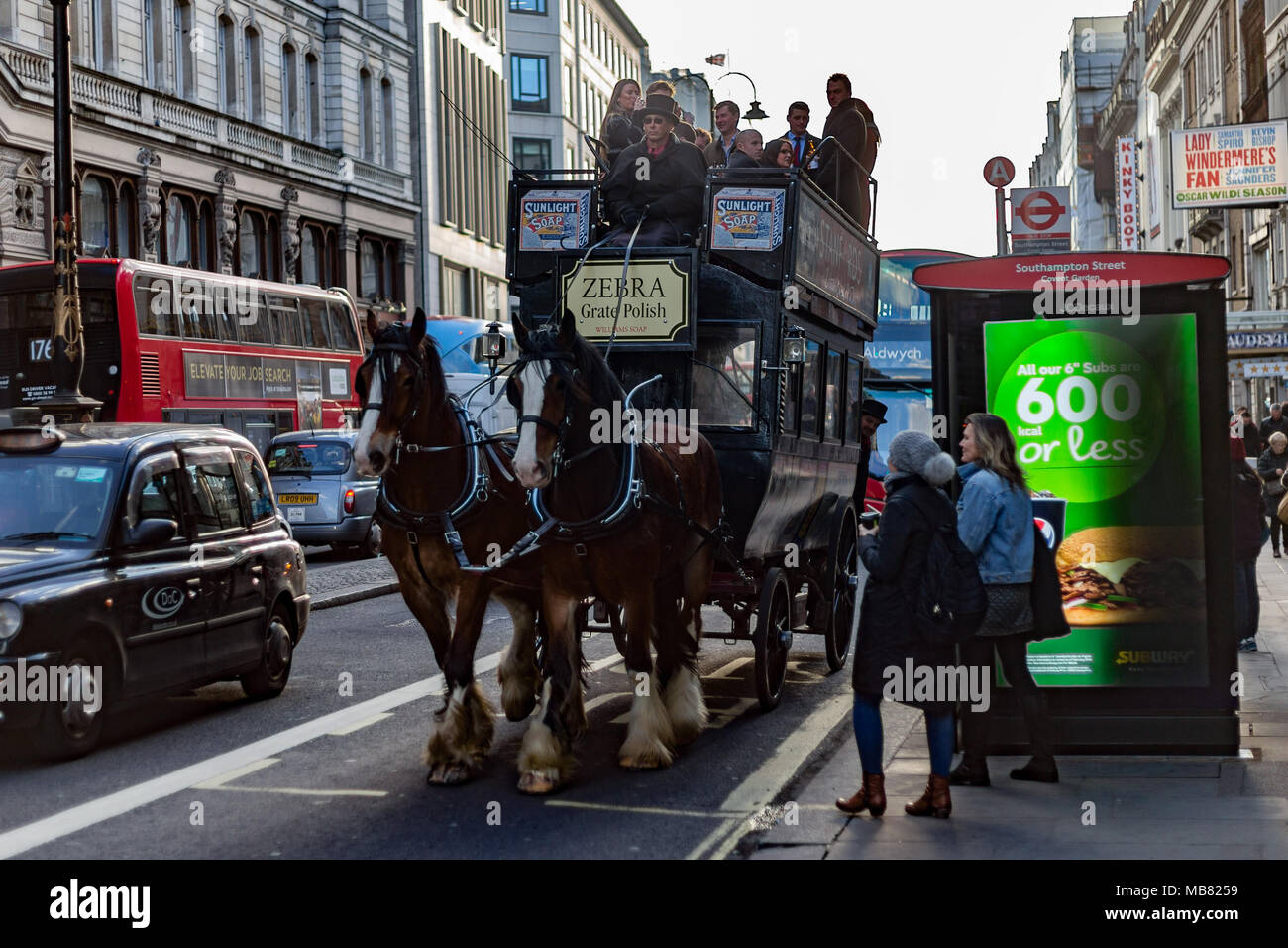A vintage horse-bus, or horse-drawn omnibus, makes it's way on the ...