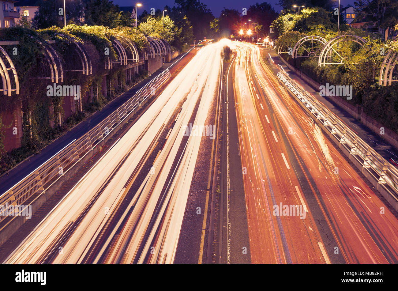 traffic light trails in green urban area Stock Photo - Alamy