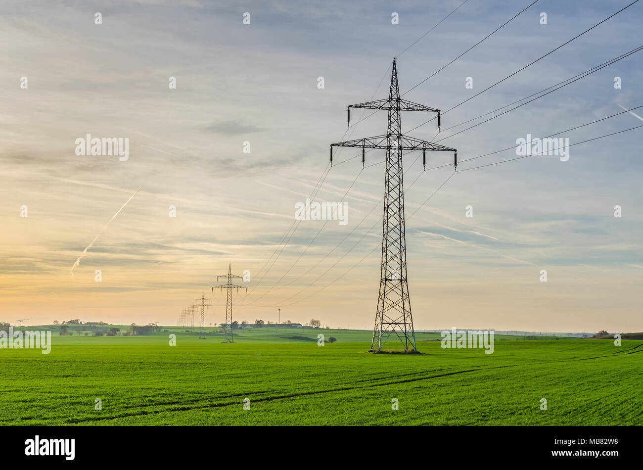 Power lines on green field hi-res stock photography and images - Alamy