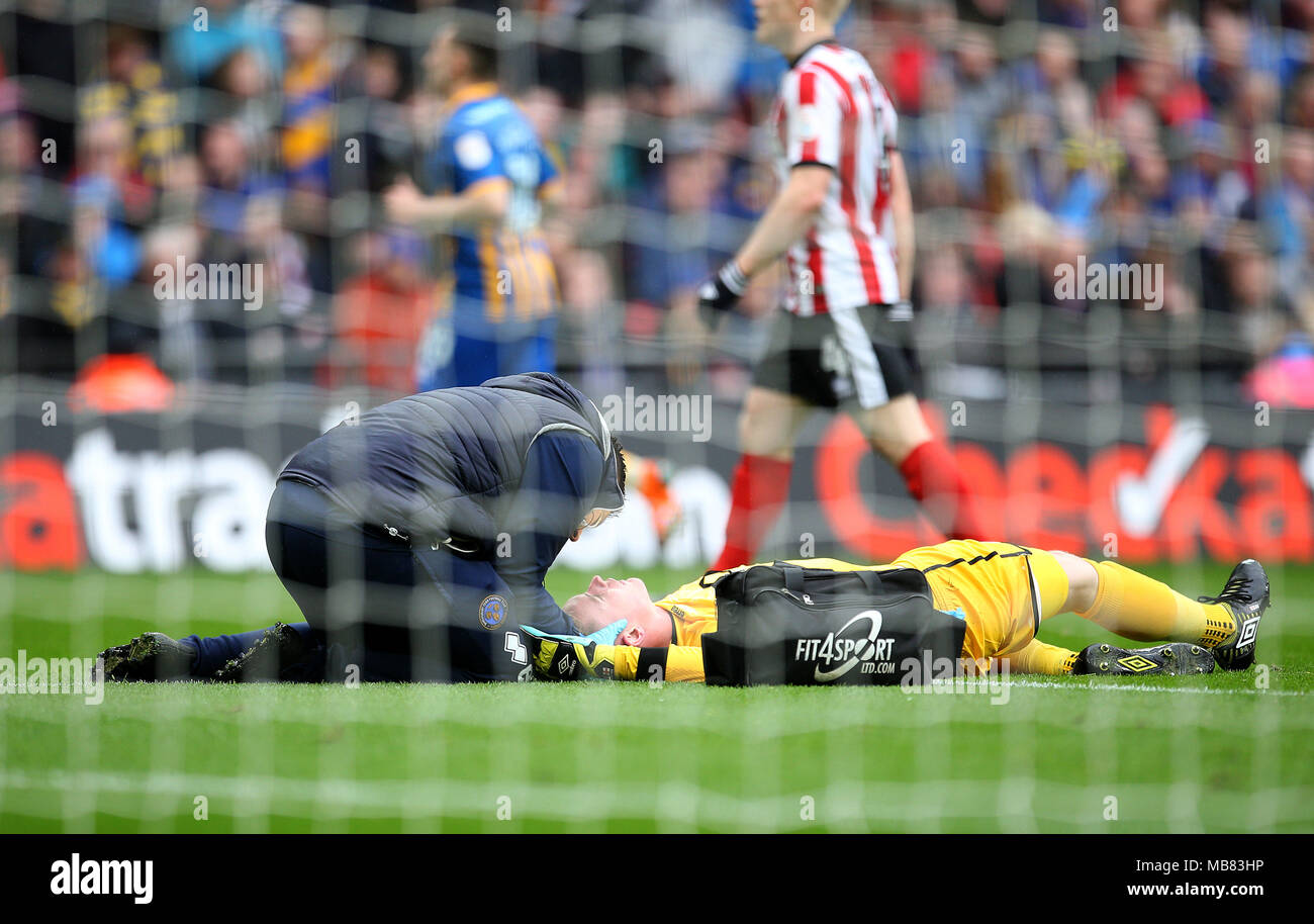 Shrewsbury Town's Dean Henderson receives treatment after colliding ...