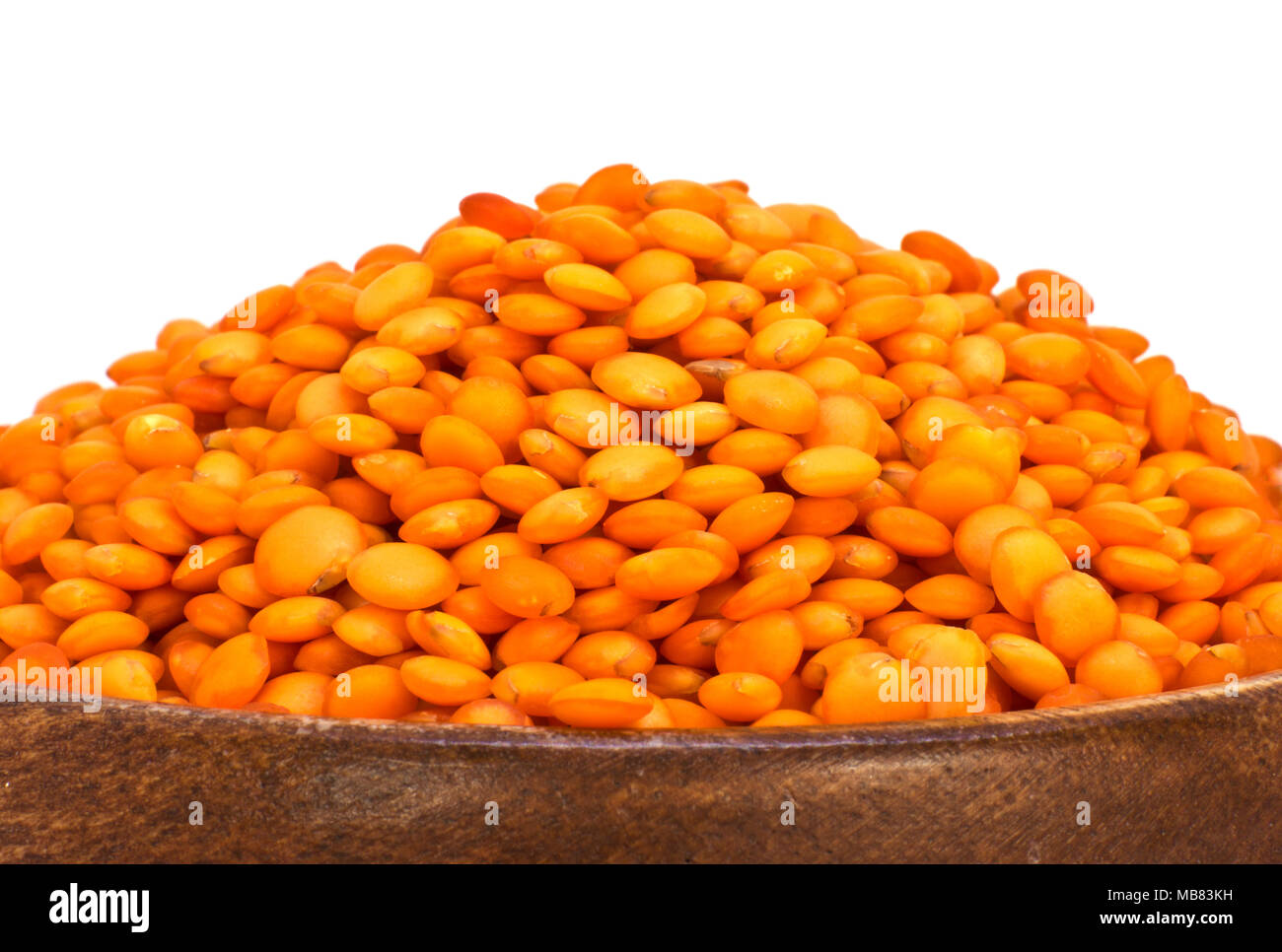 Red raw lentils in a wooden bowl. Isolated on the white background Stock Photo - Alamy