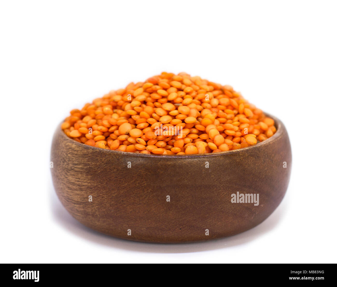 Red raw lentils in a wooden bowl. Isolated on the white background Stock Photo - Alamy