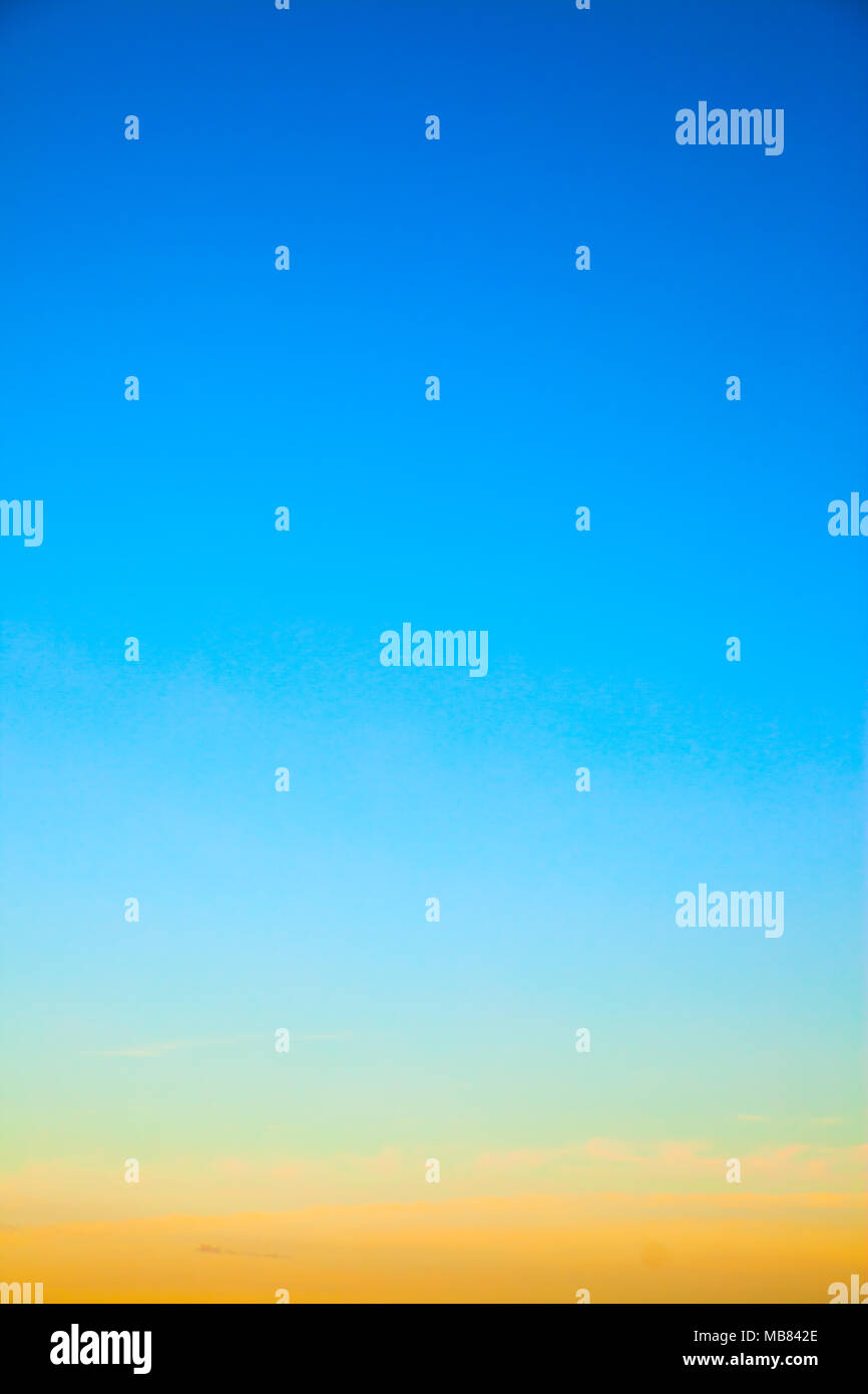 Colorful sunset sky - yellow blue natural background Stock Photo - Alamy